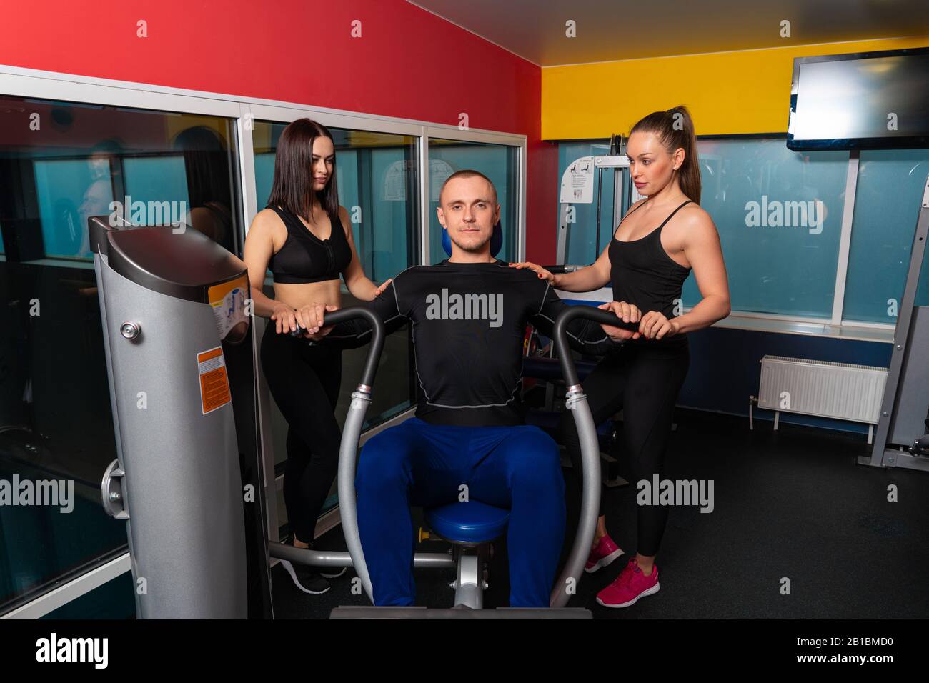 personal trainer man working with young woman in modern gym Stock Photo ...