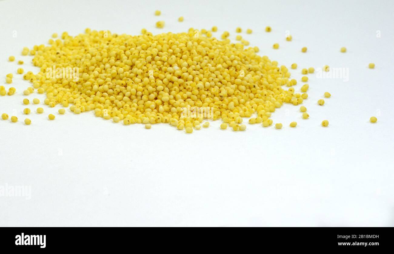 Heap of millet groats on white Stock Photo - Alamy