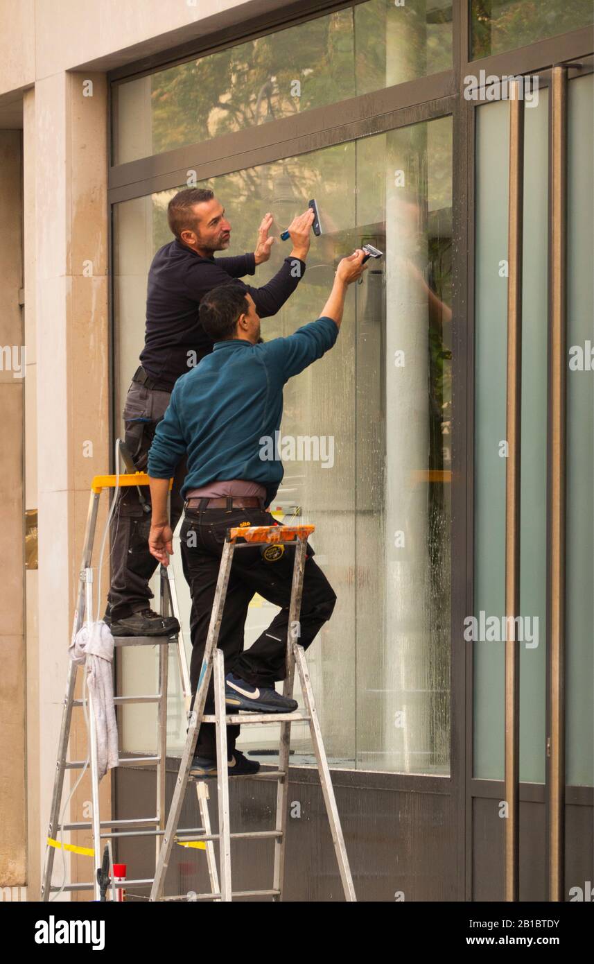 workers cleaning store windows Paris France Stock Photo - Alamy
