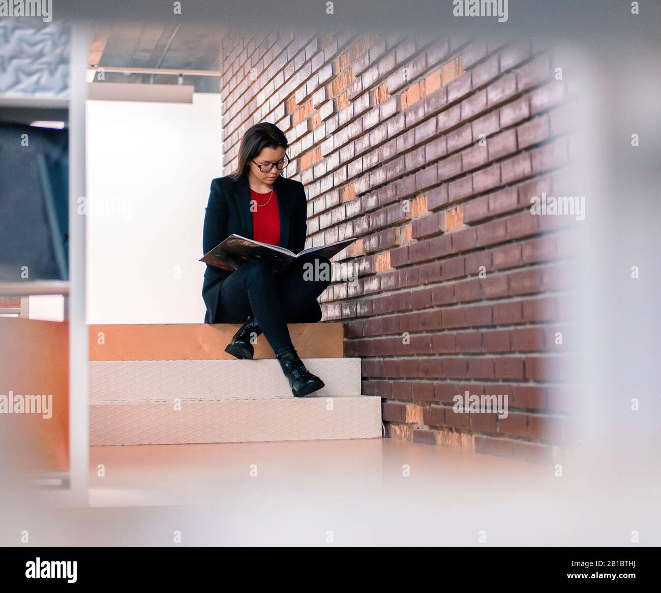 One Handed Woman In Modern Library Or Book Store Reading a Book And ...