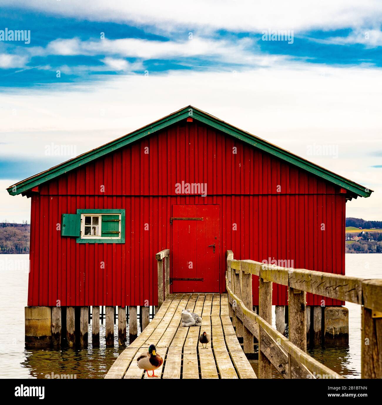 Red boat house and bridge with ducks Stock Photo - Alamy
