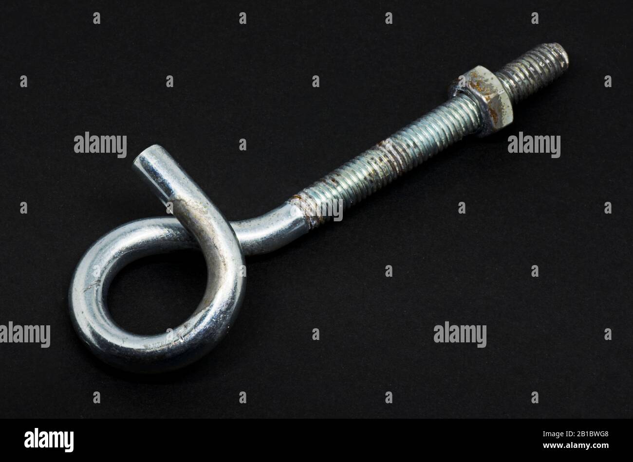 Steel pigtail screw hook on black background. Safety piece of hardware ...