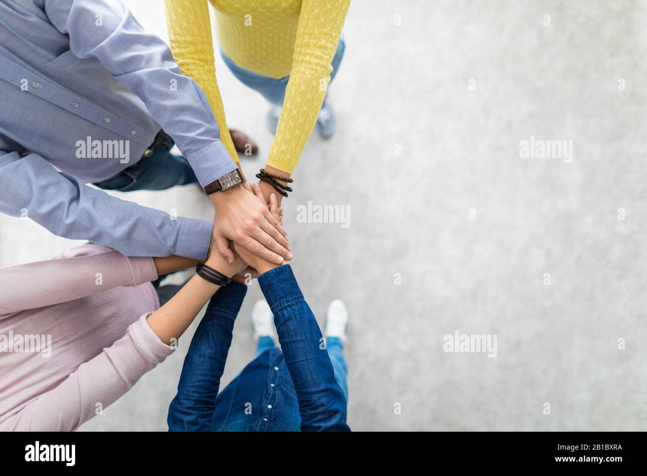 Close up top view of young business people putting their hands together. Stack of hands. Unity ...