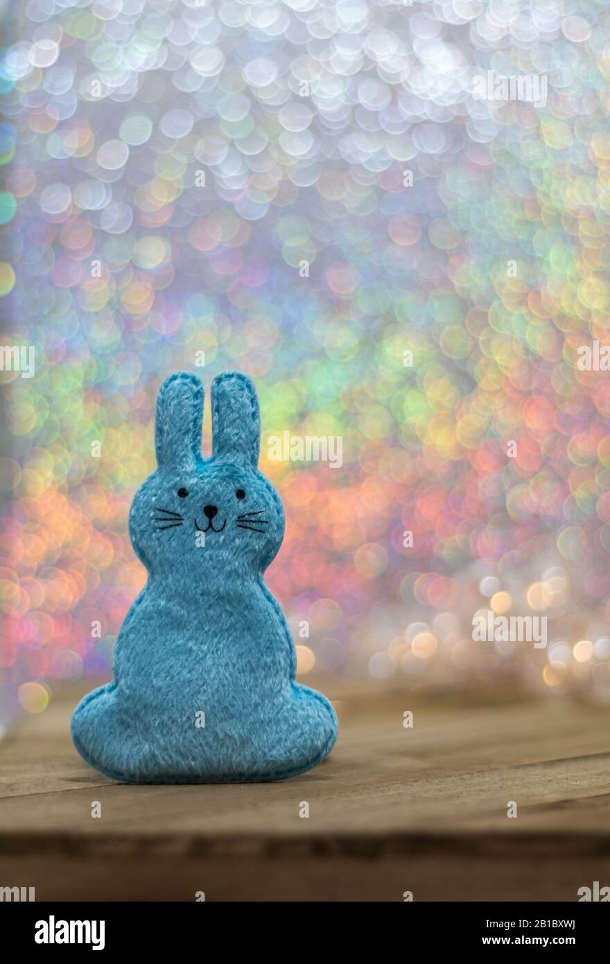 Blue bunny rabbit on wooden board with soft warm color bokeh room for ...
