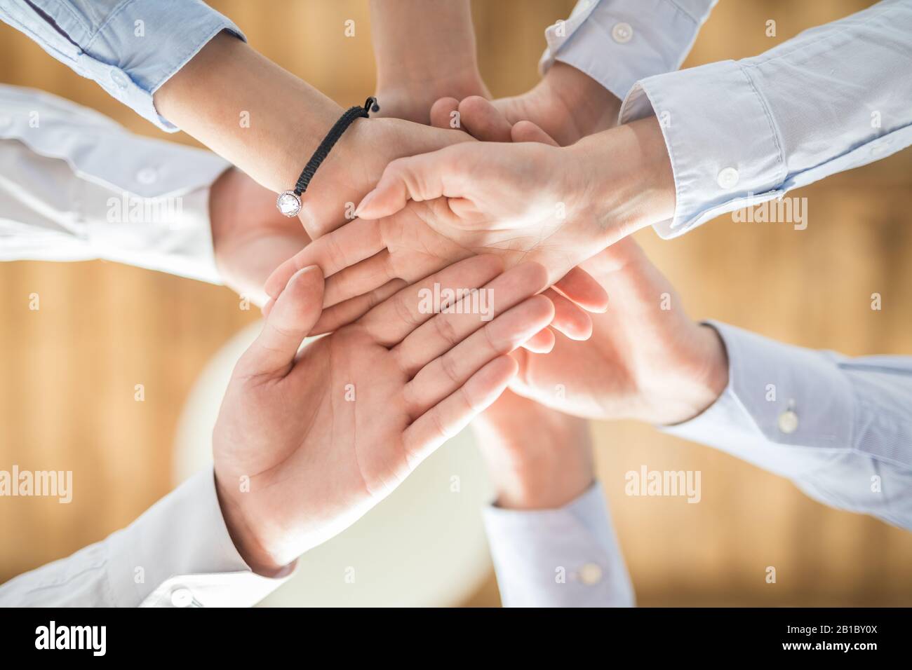 Close up top view of young business people putting their hands together. Stack of hands. Unity ...