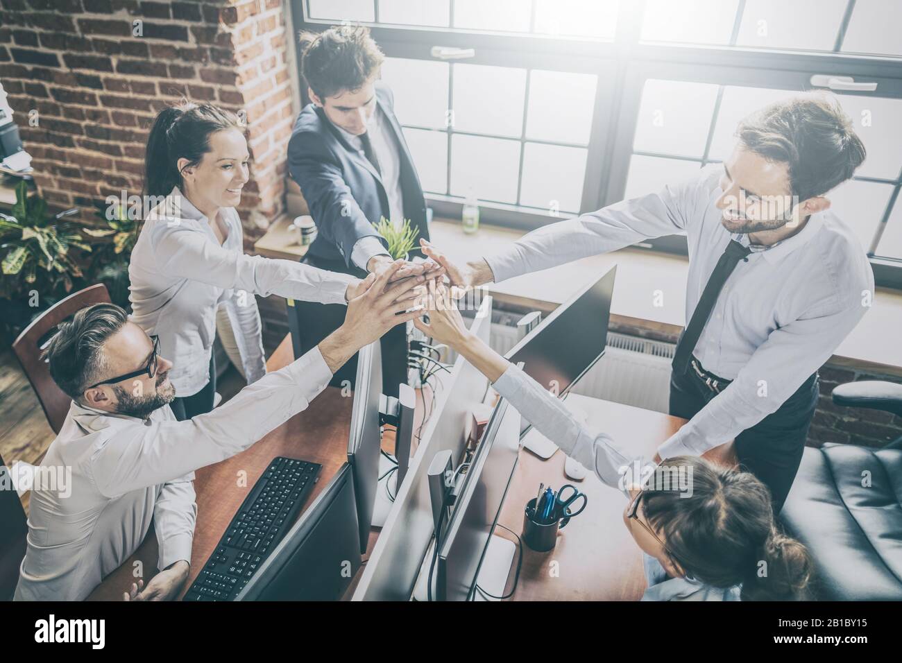 Business people happy showing team work and giving five in office ...