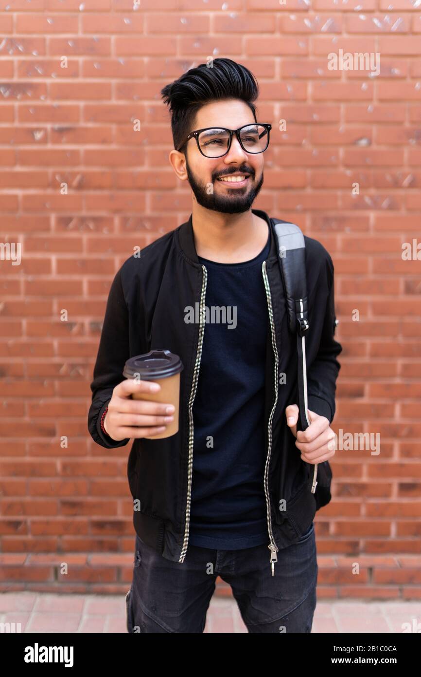 travel, tourism and lifestyle concept - smiling indian man with ...