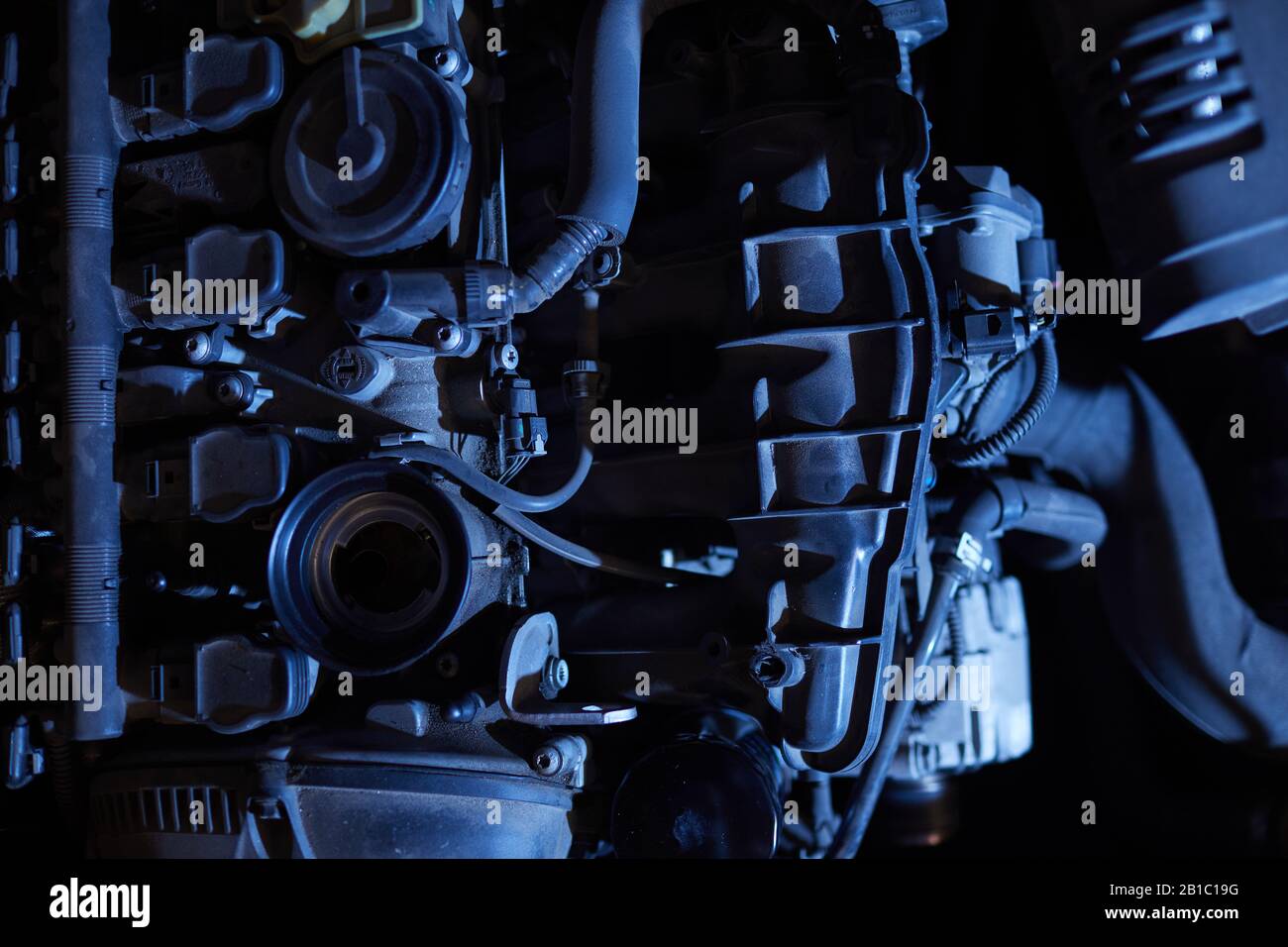 Dramatic background image of car engine in black and blue tones, auto ...