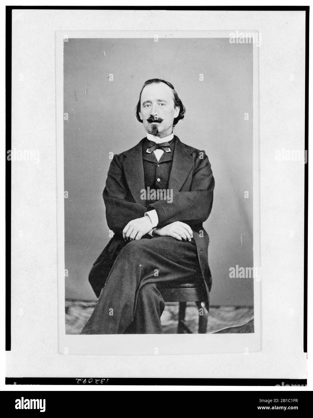 Full-length portrait of a man, seated, facing front Stock Photo - Alamy