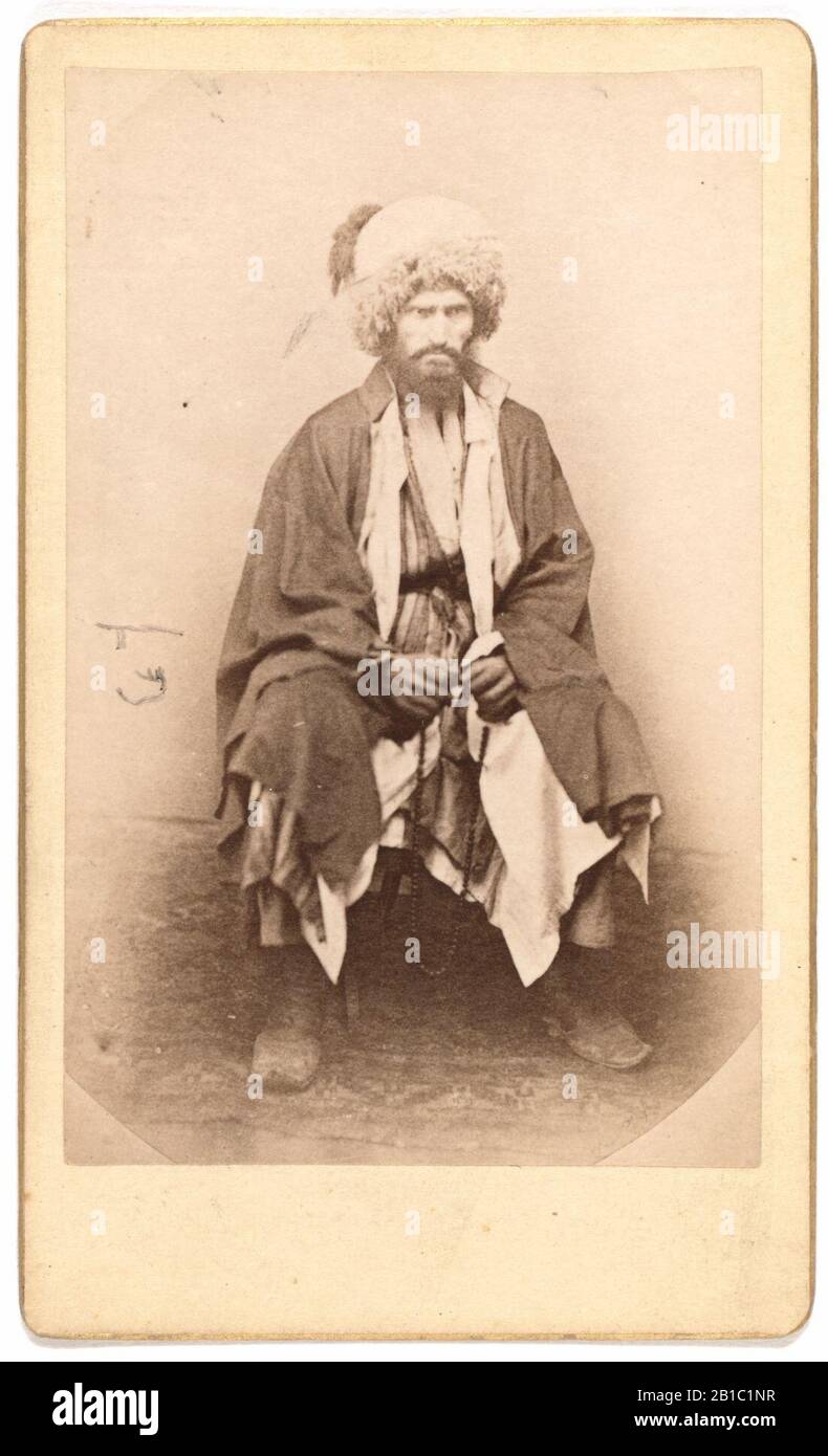 Full-length portrait of man, seated, facing front Stock Photo - Alamy