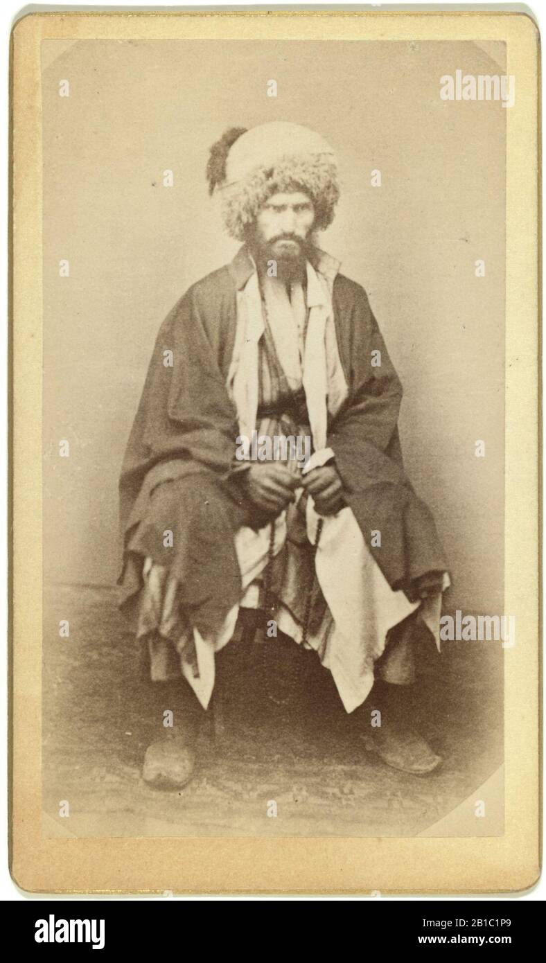 Full-length portrait of man, seated, facing front Stock Photo - Alamy