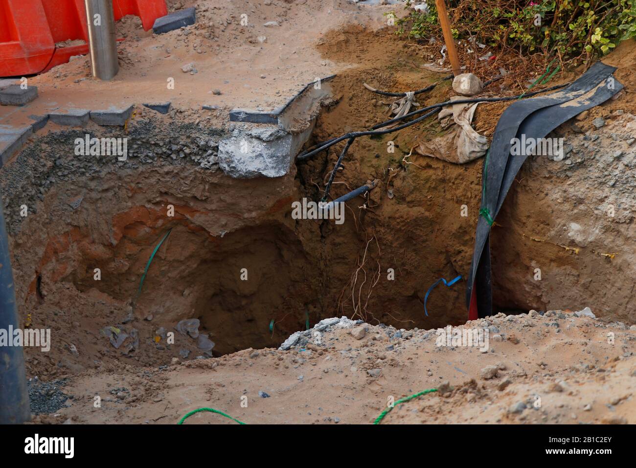 deep excavation near the foot path due to underground cable work Stock ...