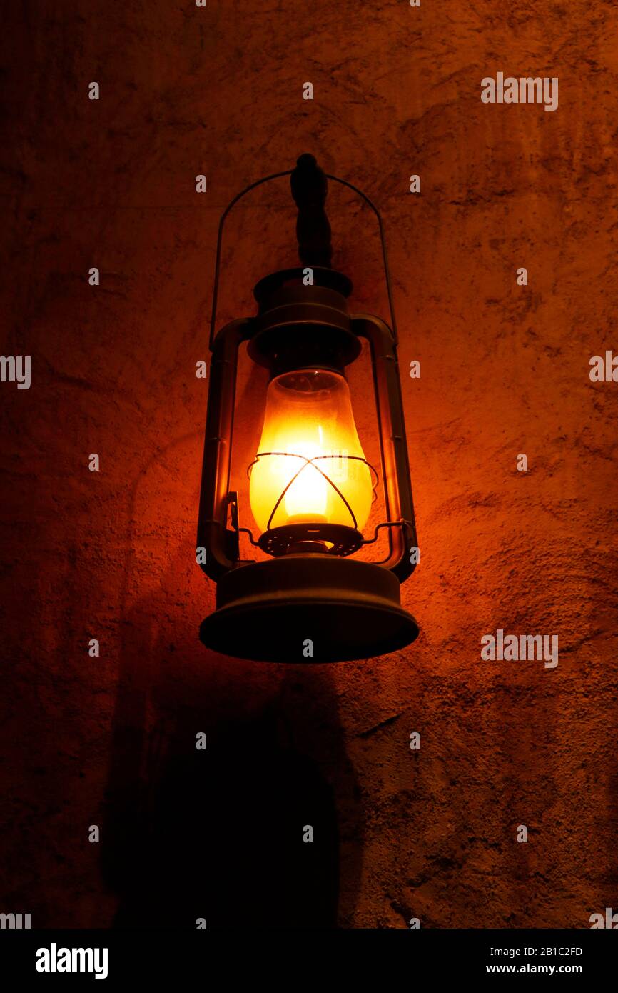 lantern lamp hanging in the night on a wall Stock Photo - Alamy