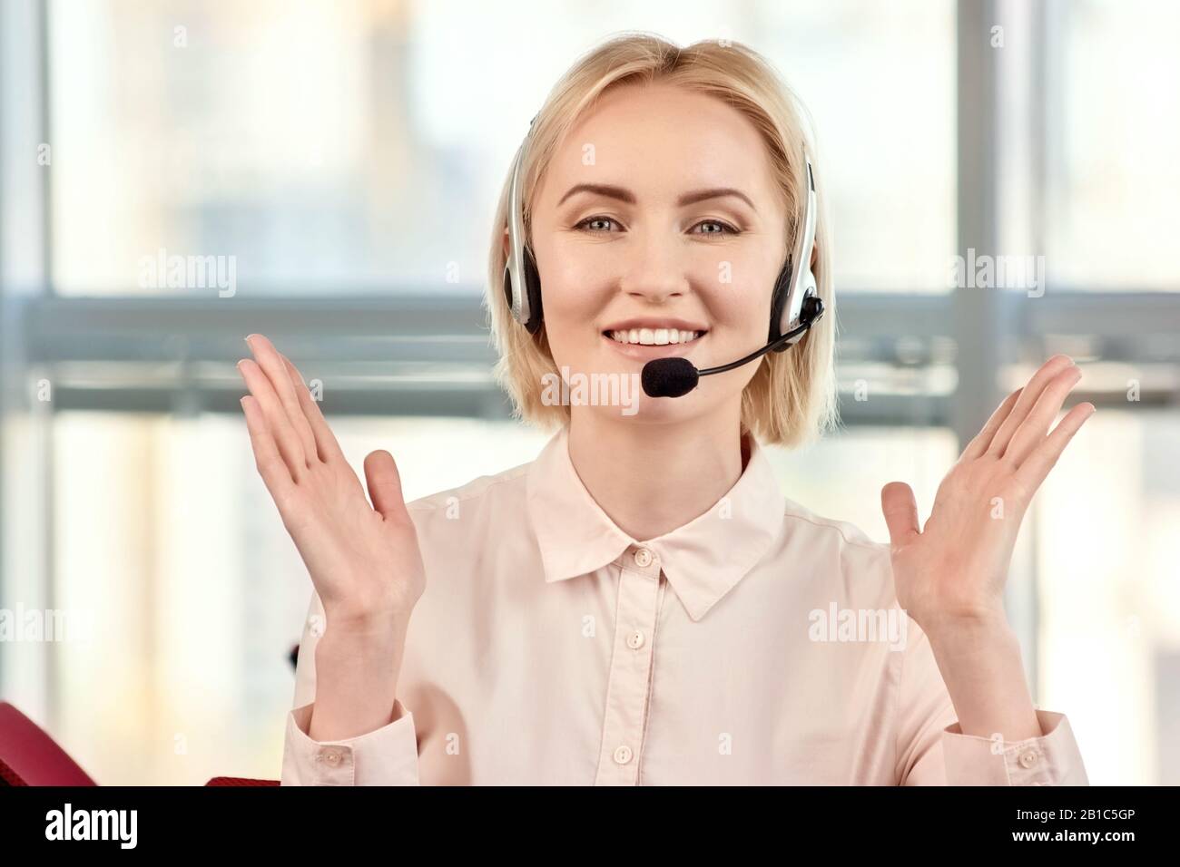 Portrait of call center operator put hands up Stock Photo - Alamy