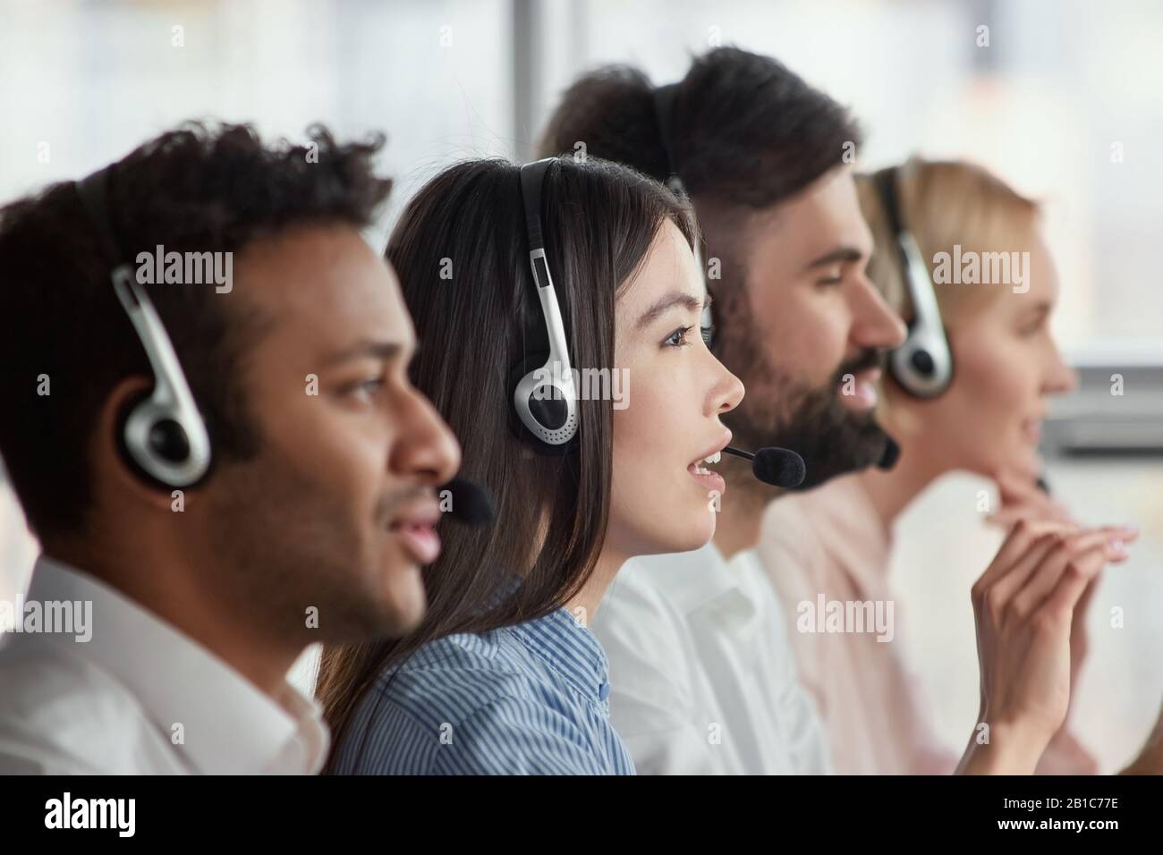 Asian young service support operator, side view Stock Photo - Alamy