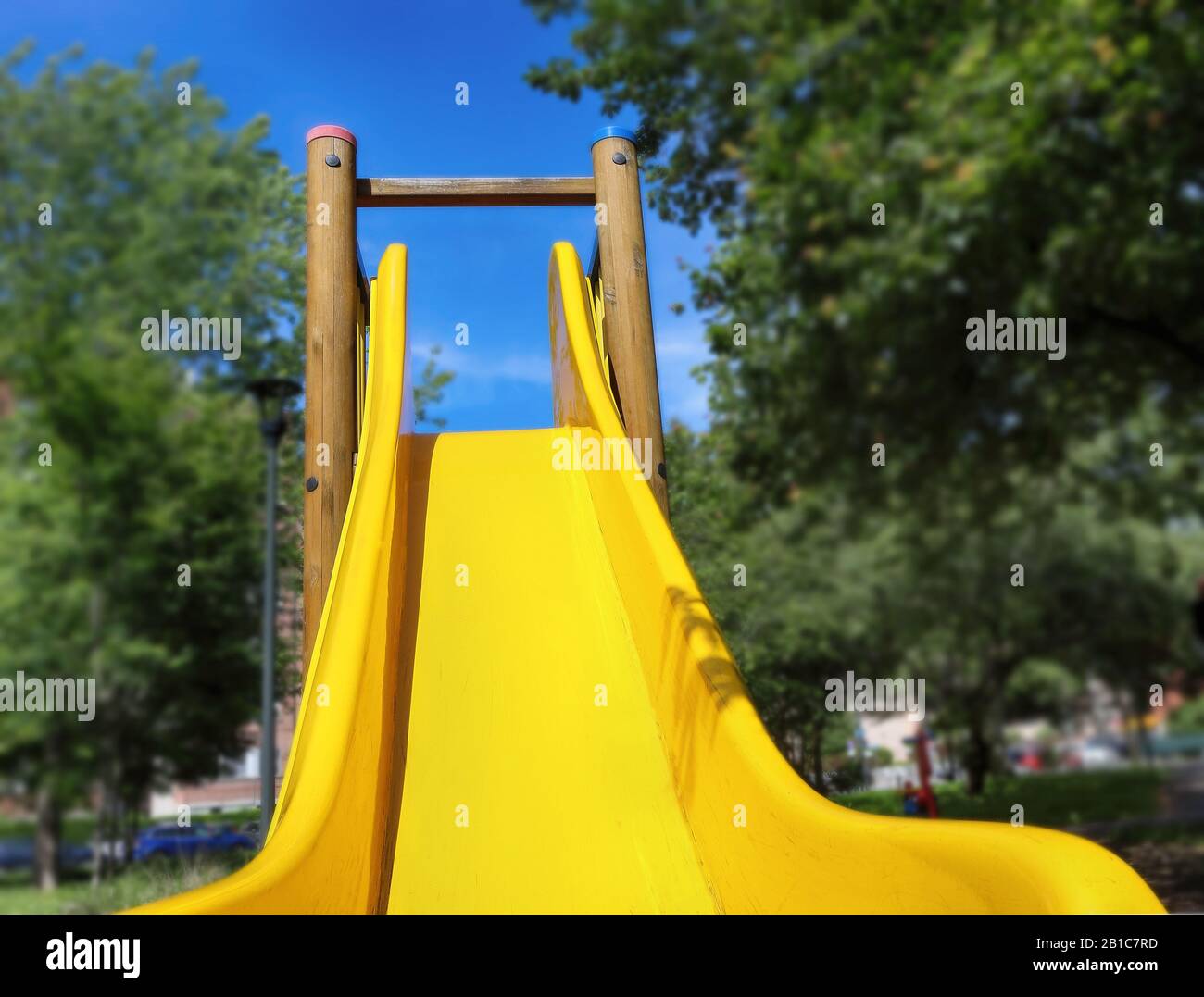 childrens slide in the park with green trees Stock Photo - Alamy
