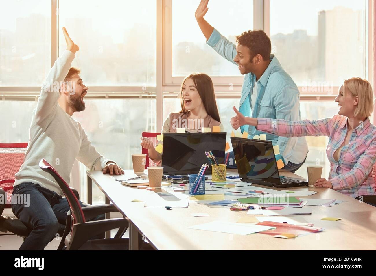 Business men in casual cloth doing high five Stock Photo - Alamy