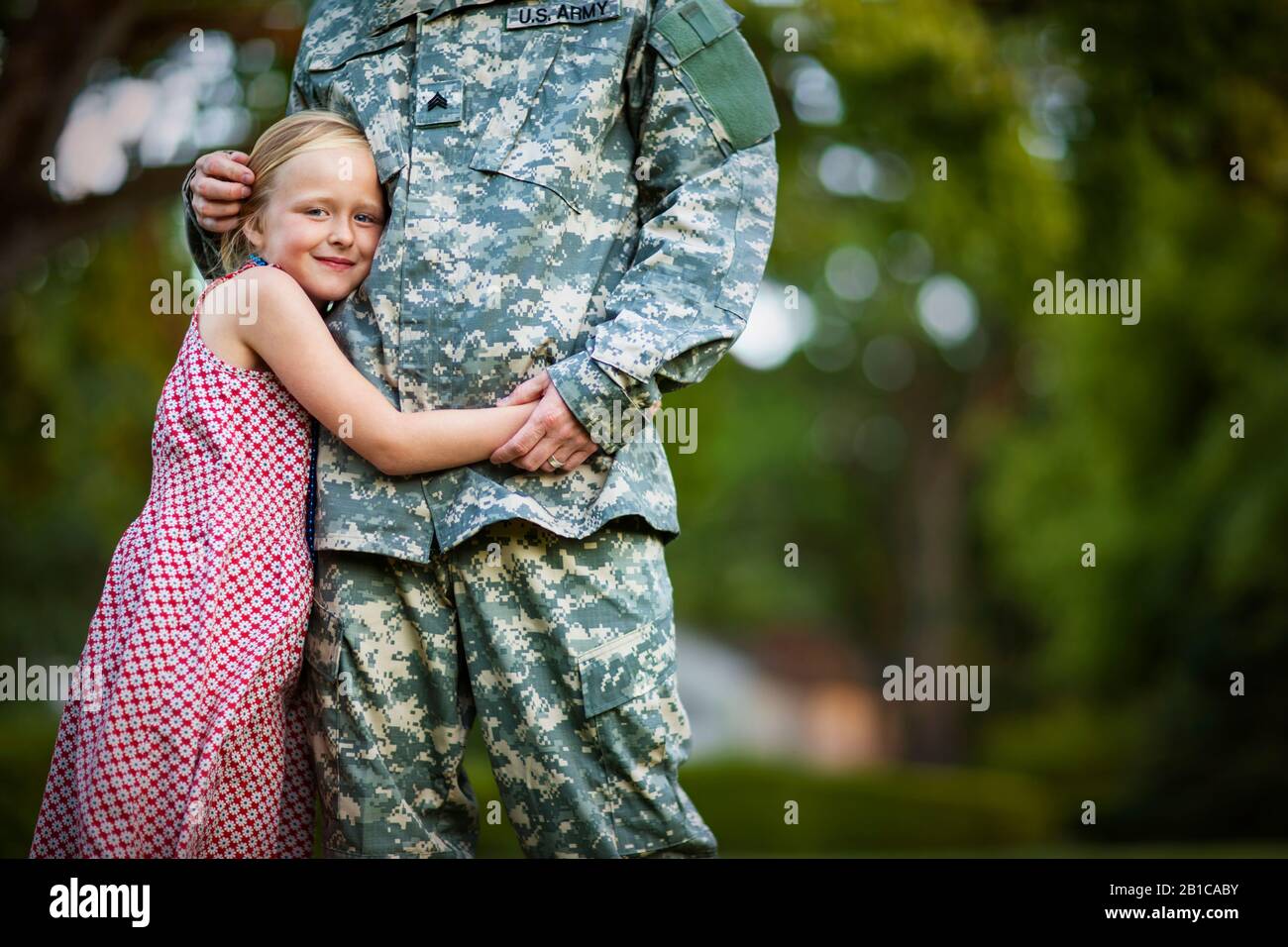 Young girl and mid adult man in army uniform smiling Stock Photo - Alamy