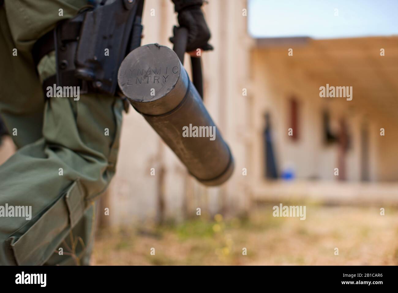 Soldier carrying a weapon towards a building in a battle zone Stock ...