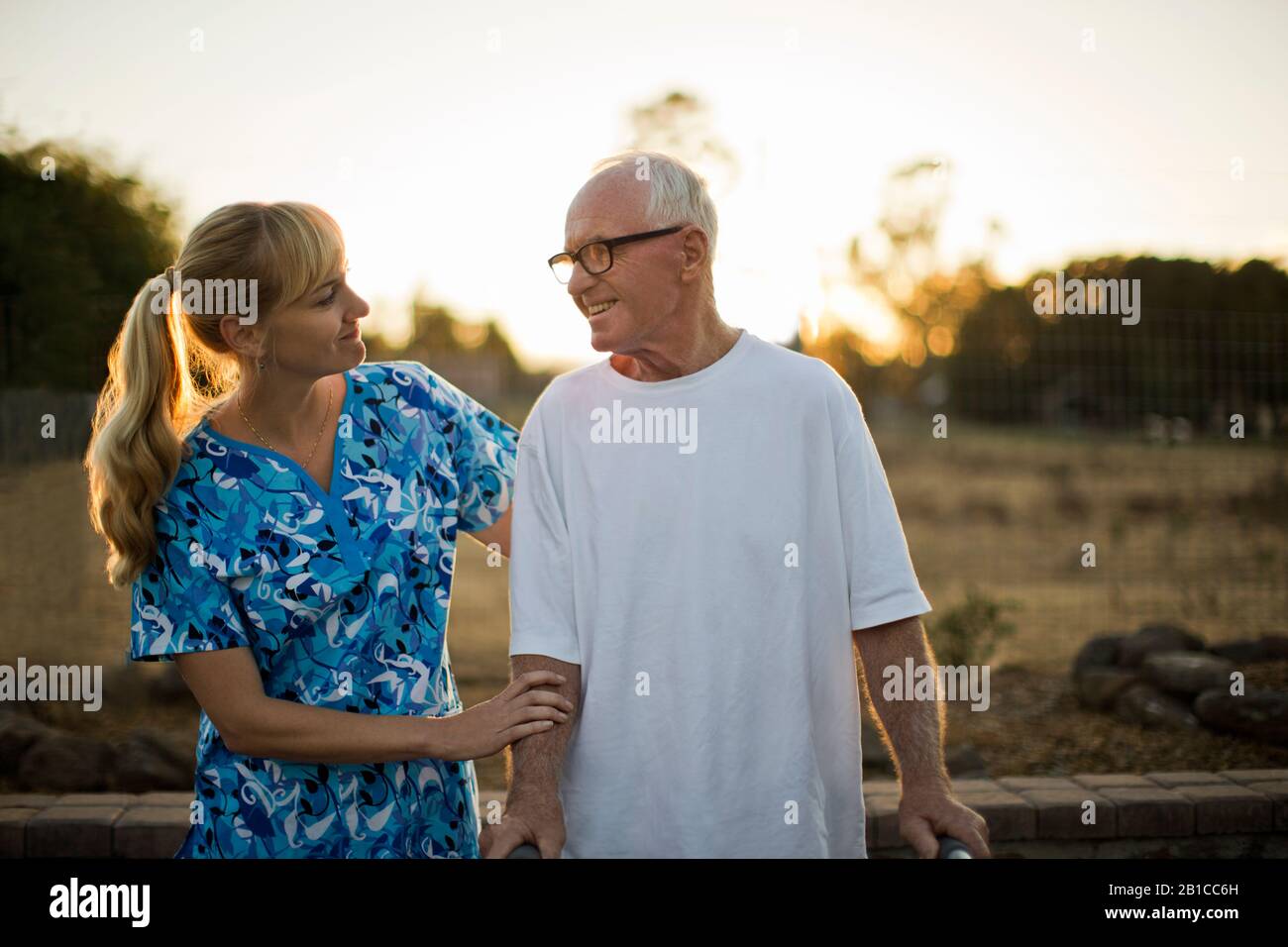 Happy Young Nurse Comforting A Senior Man Stock Photo Alamy