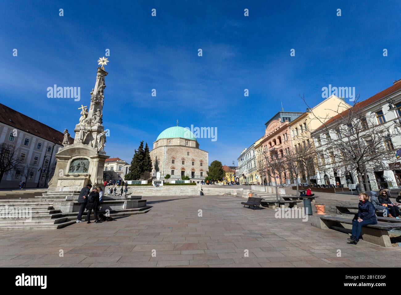 Pecs, Hungary - 02 22 2020: Holy Trinity statue with the mosque of ...