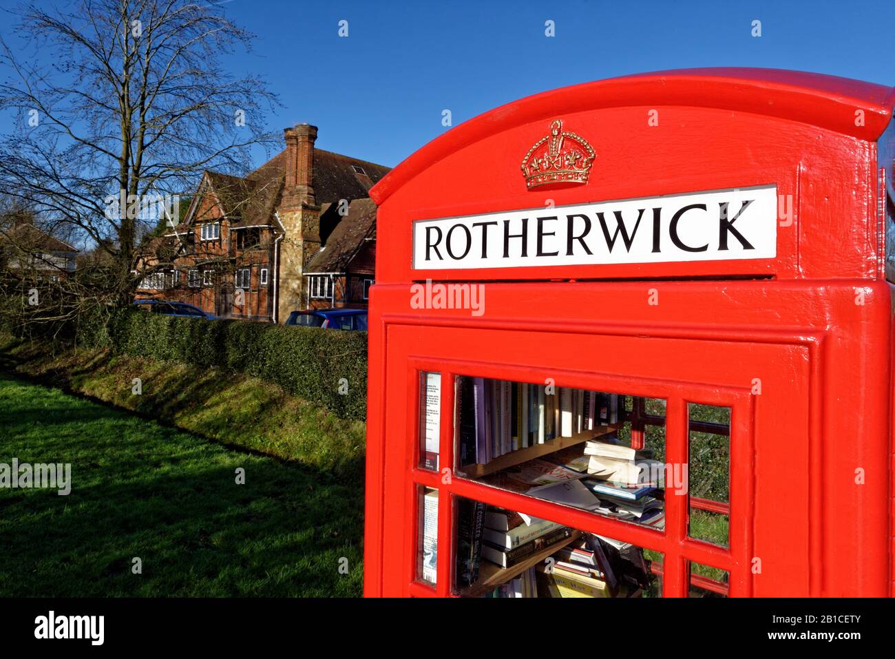 Rotherwick village red library telephone box Stock Photo - Alamy
