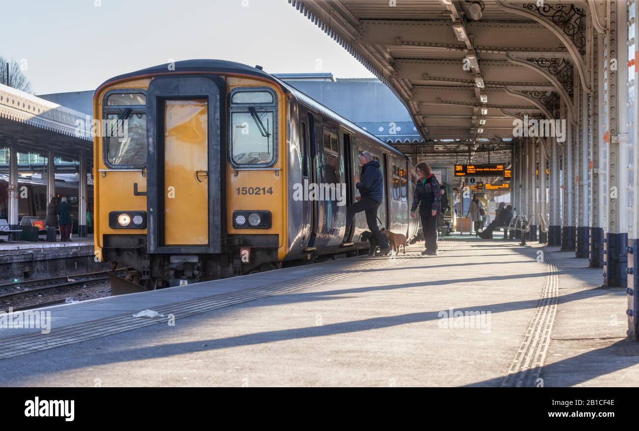 Passengers boarding Arriva Northern rail class 150 sprinter train ...