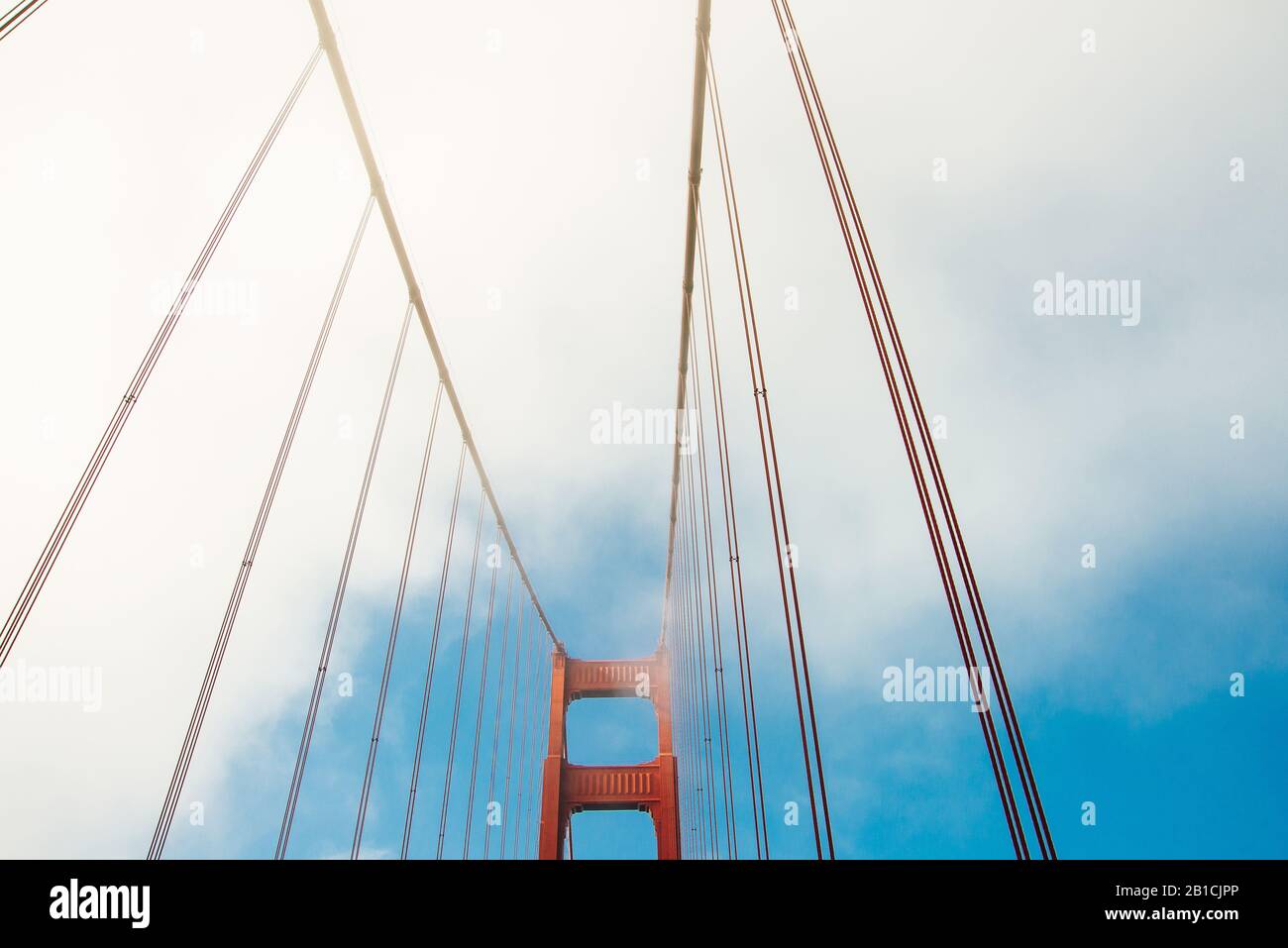 Close up of single tower of Golden Gate Bridge in white clouds San ...