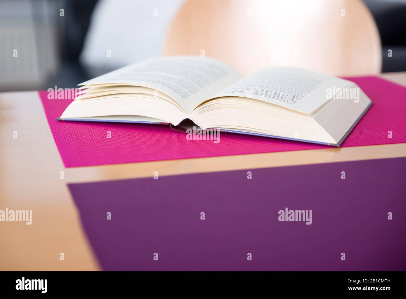 Open book lying on a table Stock Photo - Alamy