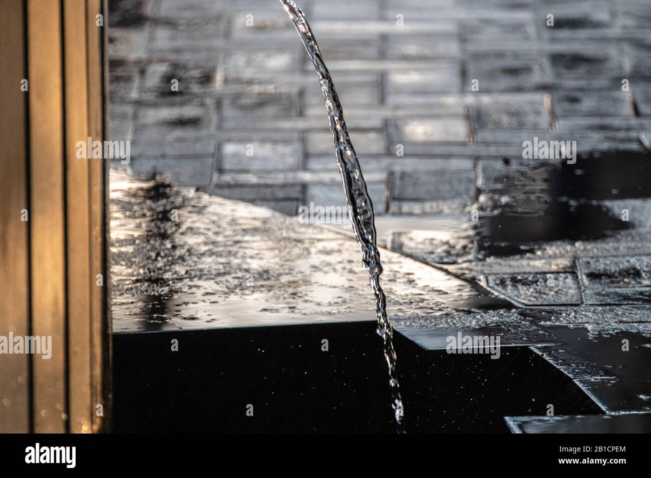 Clear drinking spring water sparking in sunset light and running from ...