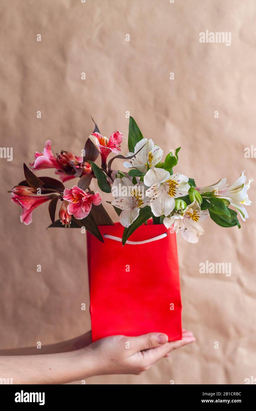 Flower shop. Giving flowers. Hands holding spring flowers bouquet ...