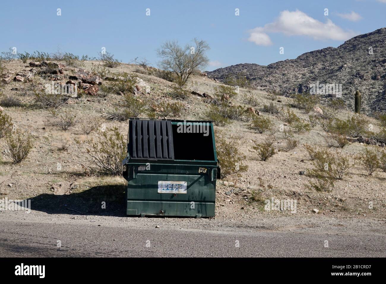 A giant trash dumpster sits in the middle of the Arizona desert Stock ...