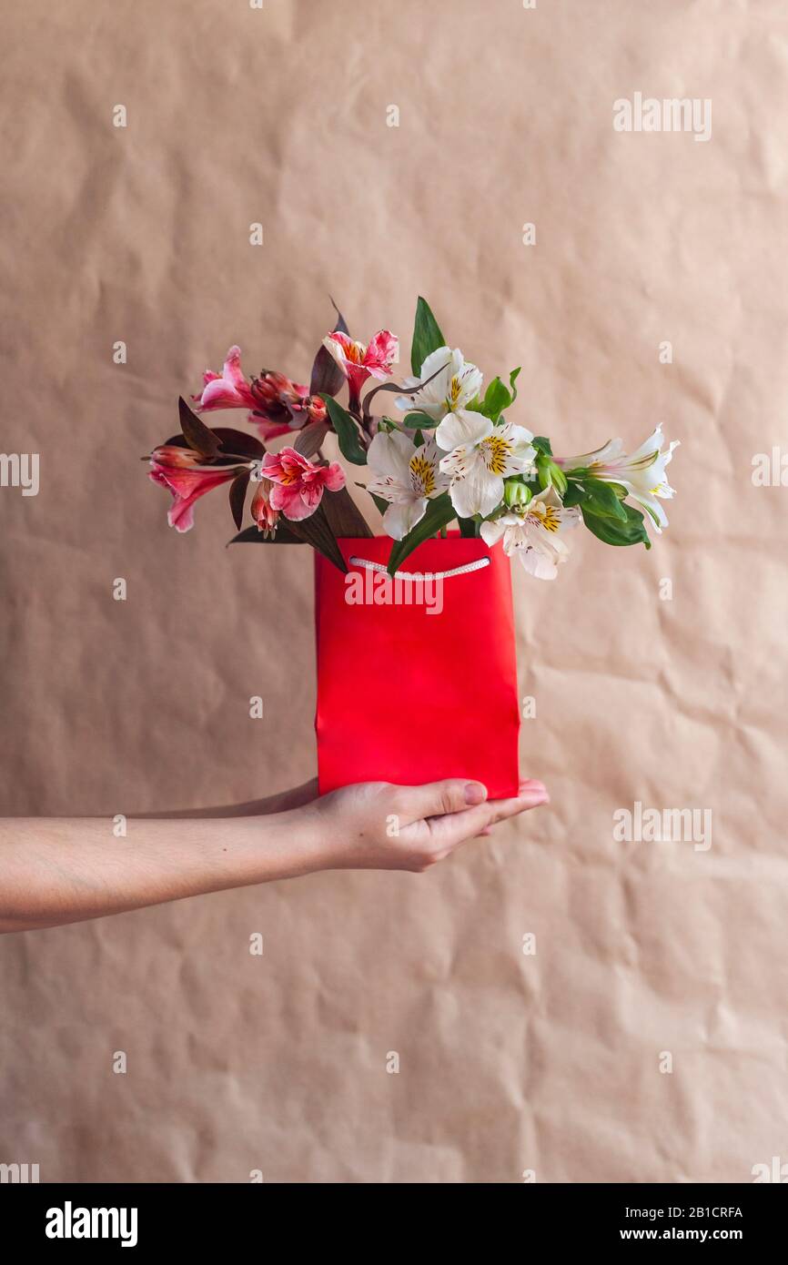Flower shop. Giving flowers. Hands holding spring flowers bouquet ...