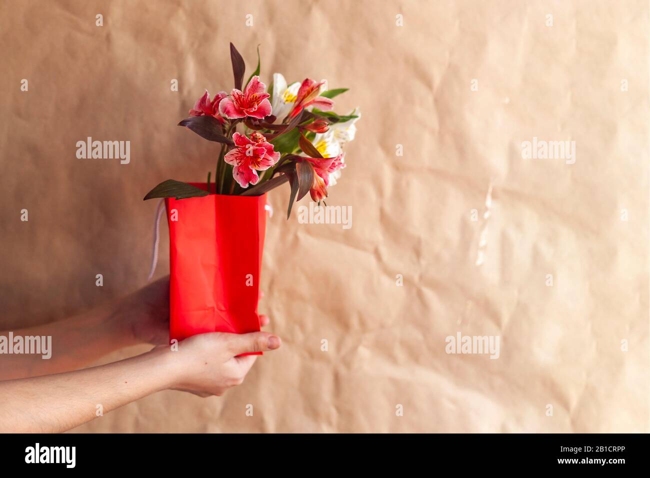 Flower shop. Giving flowers. Hands holding spring flowers bouquet ...