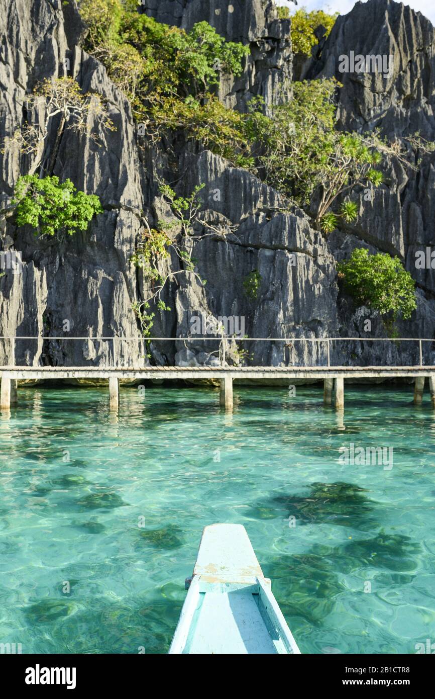 Stunning view of a blue canoe sailing on a turquoise, crystal clear ...
