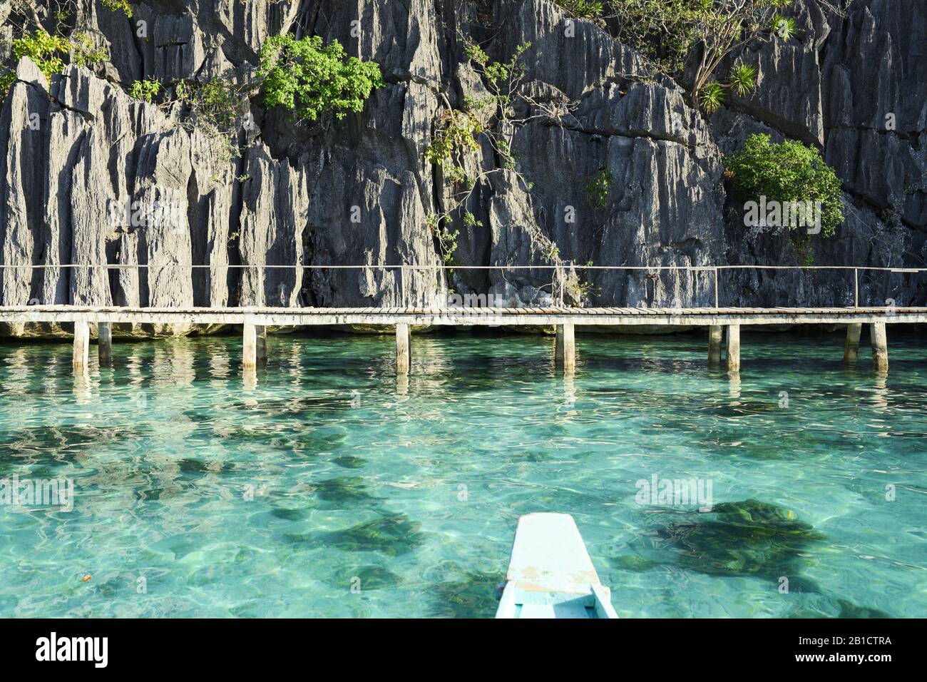Stunning view of a blue canoe sailing on a turquoise, crystal clear ...