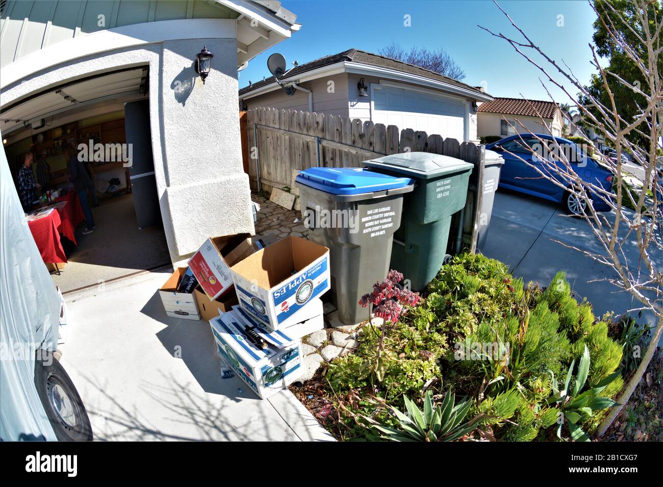 Trash and cans and dumpster for pickup by recycling and disposal ...