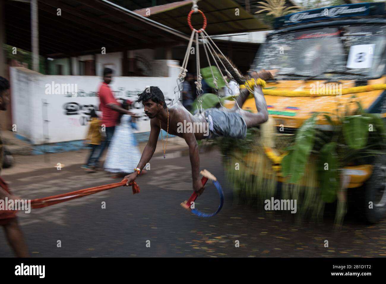 Devotee hanging by hook piercings as a ritualistic act of devotion ...
