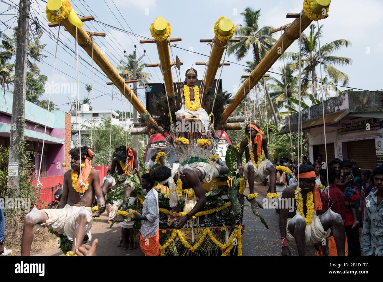 Devotees hanging by hook piercings as a ritualistic act of devotion ...