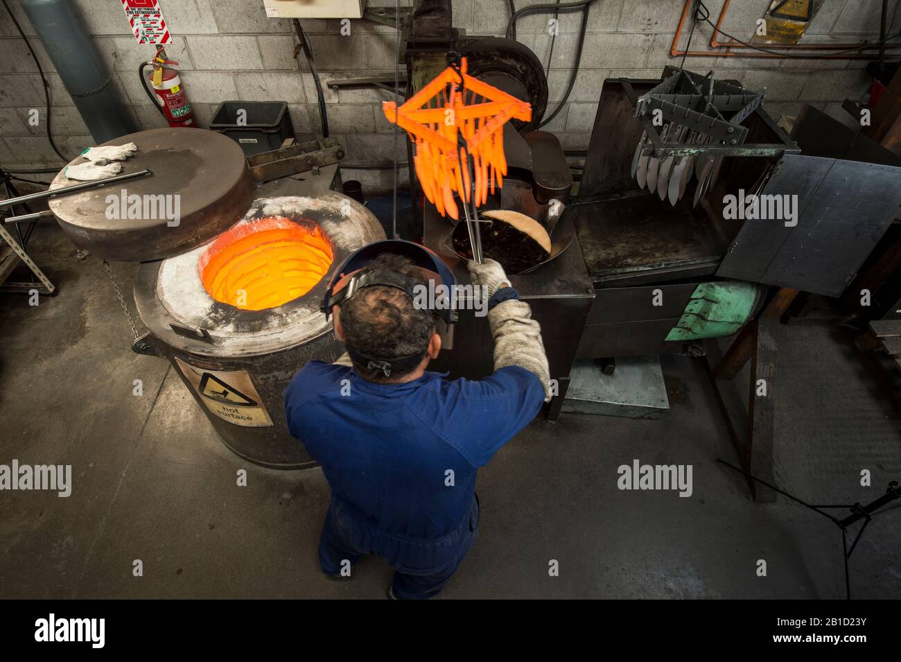 Knife blades being tempered Stock Photo - Alamy