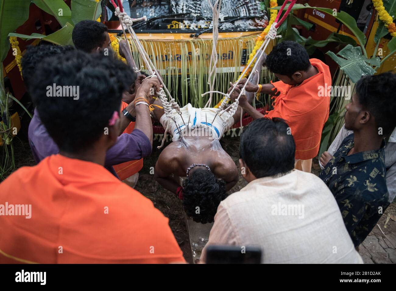 Devotee hanging by hook piercings as a ritualistic act of devotion ...