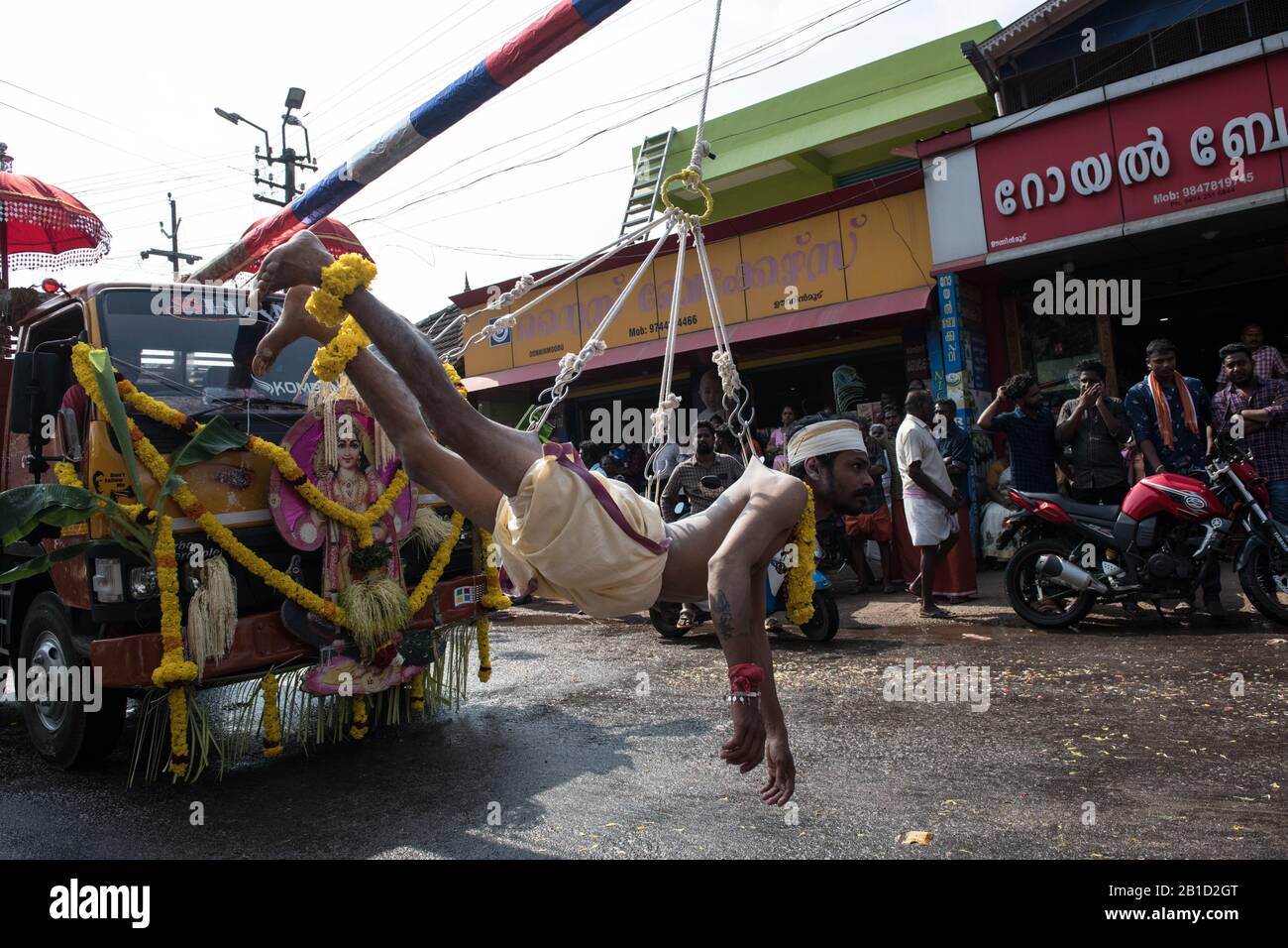 Devotee hanging by hook piercings as a ritualistic act of devotion ...