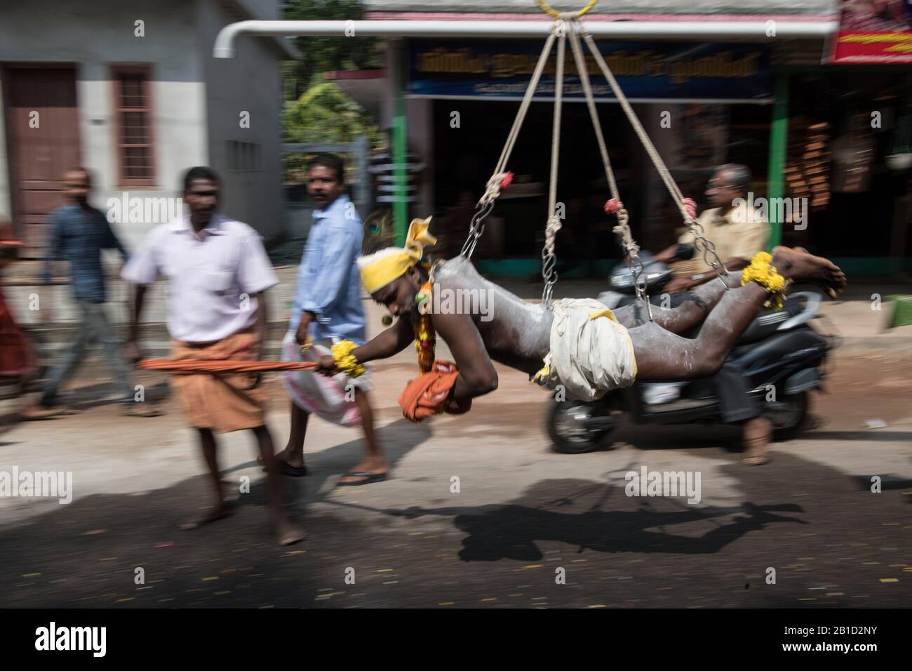 Devotee hanging by hook piercings as a ritualistic act of devotion ...