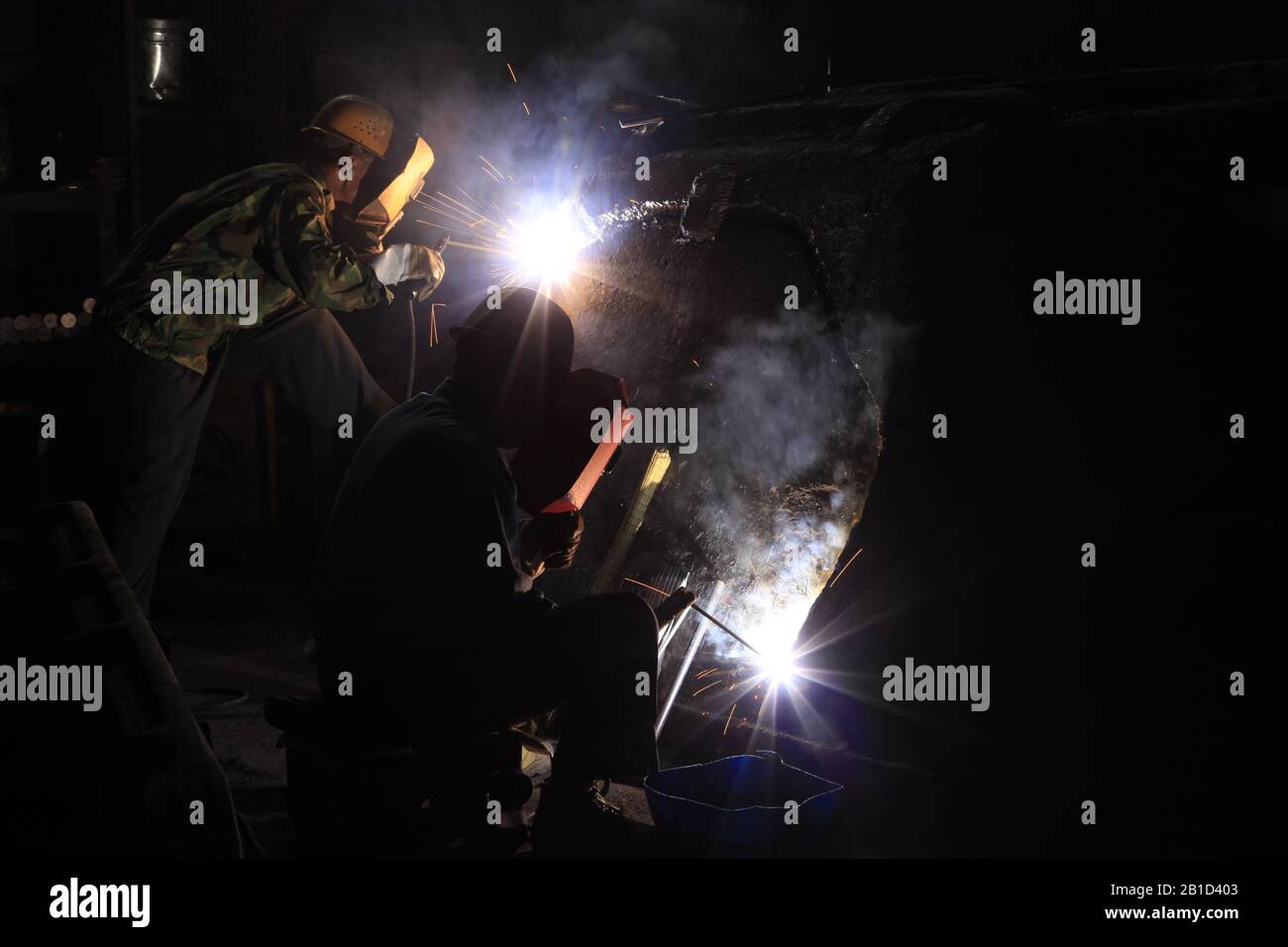 In the steel mill workshop, welding workers are working Stock Photo - Alamy