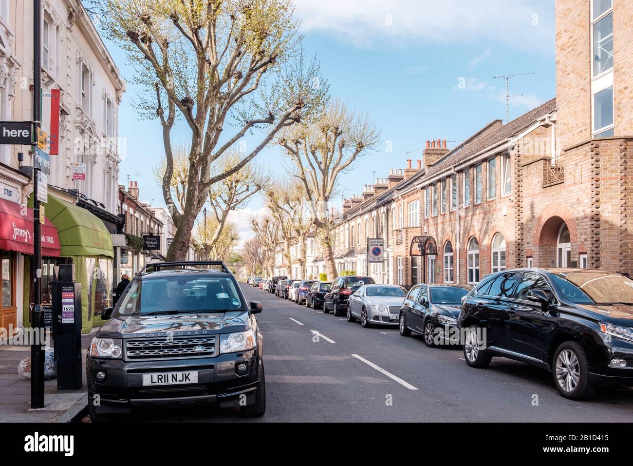 Cars parked in controlled zone of Elliott Road, Chiswick, London Stock ...