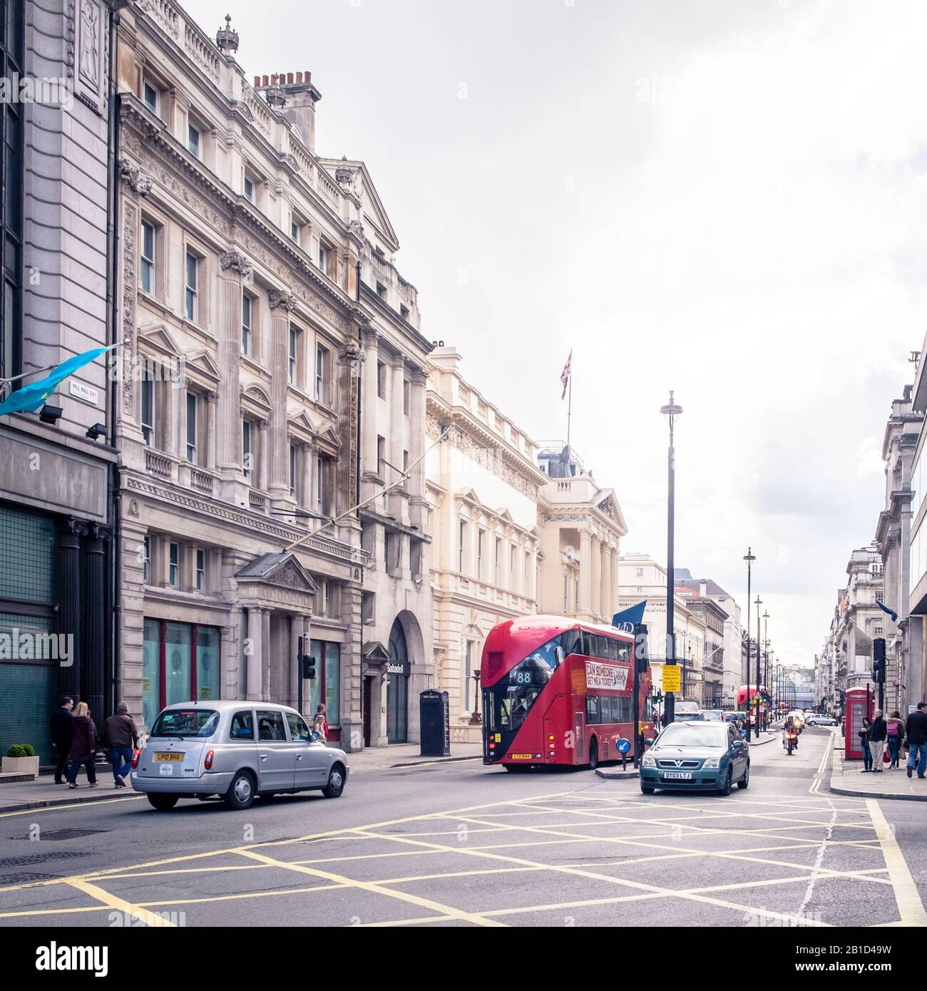 Public transportation and cars passing by on a street in London ...