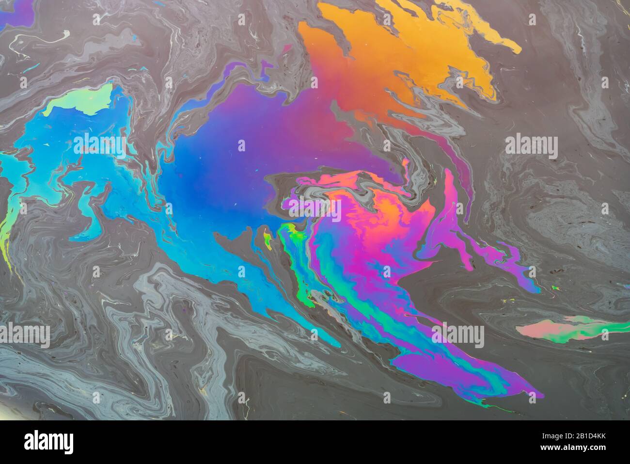 Pollution from a colored oil stain on the water surface Stock Photo - Alamy