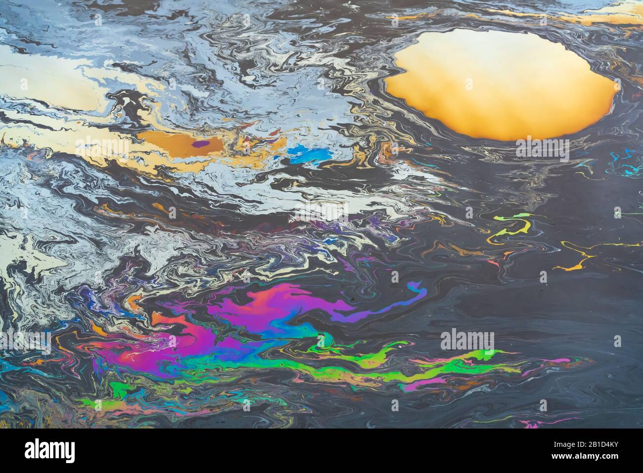 Pollution from a colored oil stain on the water surface Stock Photo - Alamy