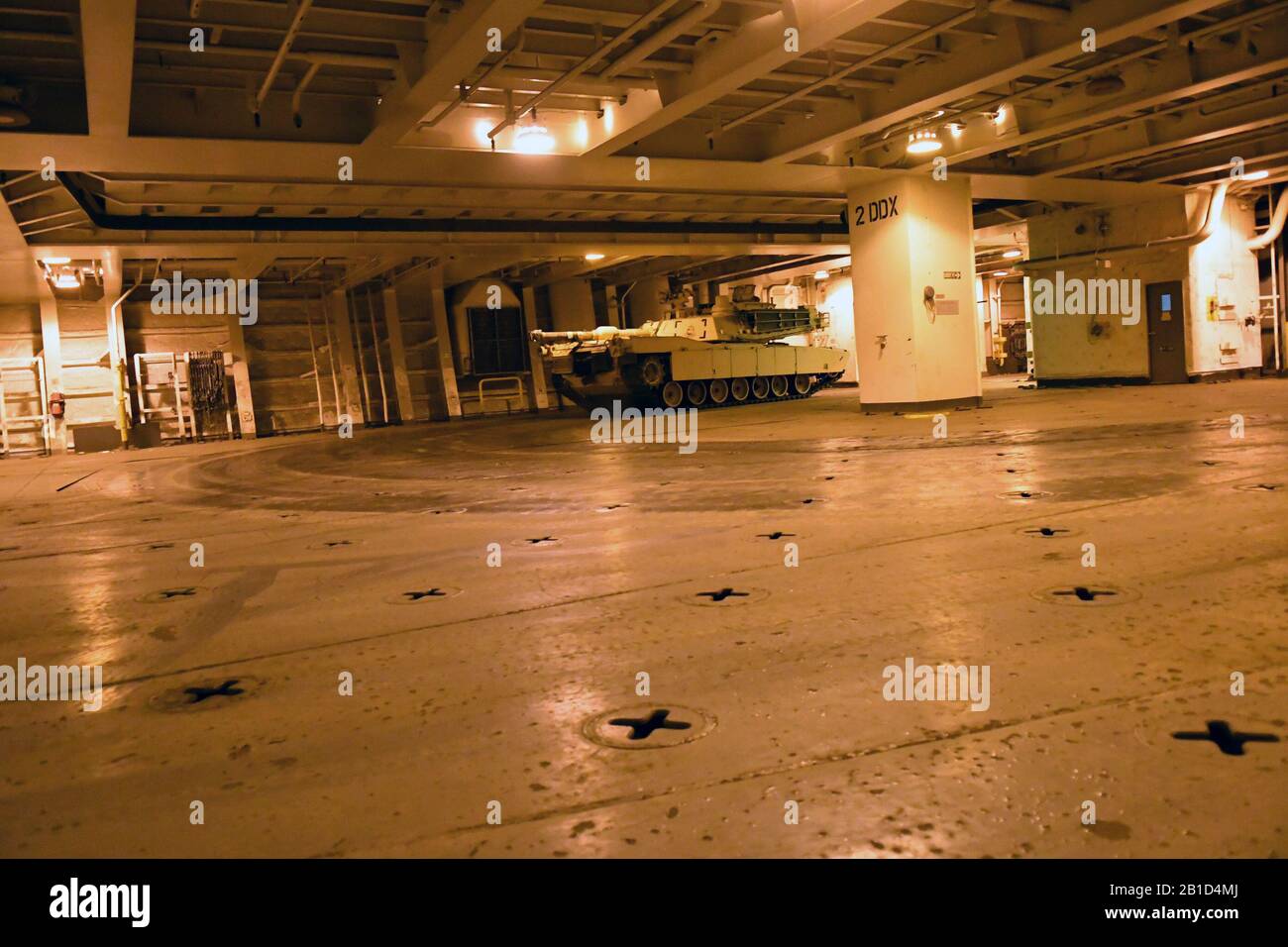 An A1 Abrams tank navigates through the decks of the Bob Hope-class ...