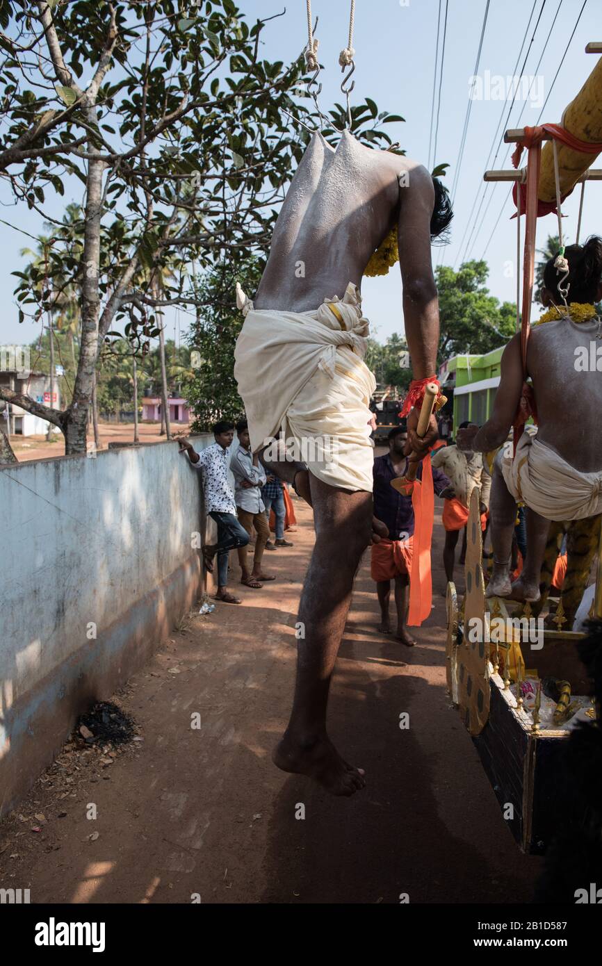 Devotee hanging by hook piercings as a ritualistic act of devotion ...